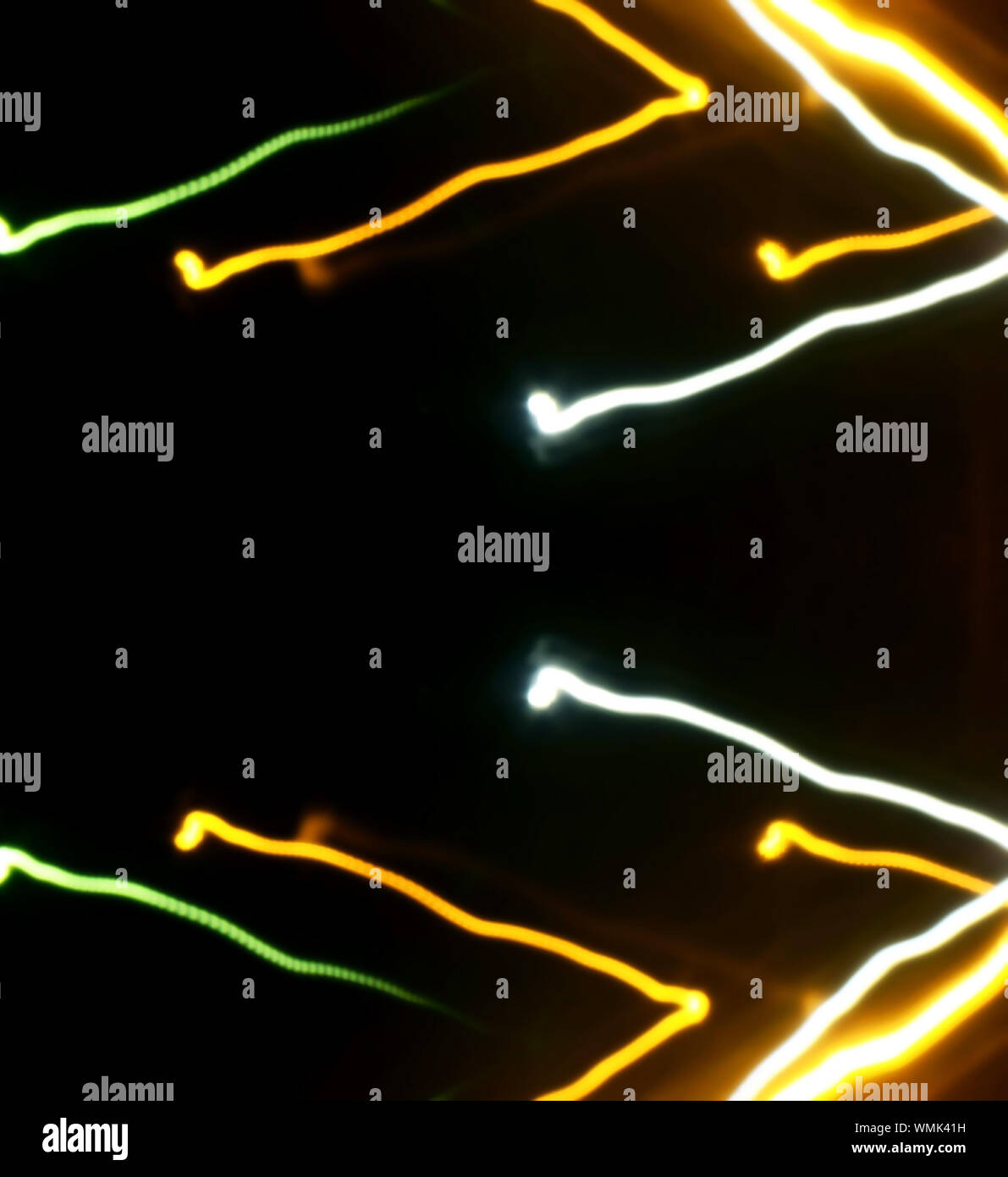 Colorful light streaks glowing on black background Stock Photo - Alamy