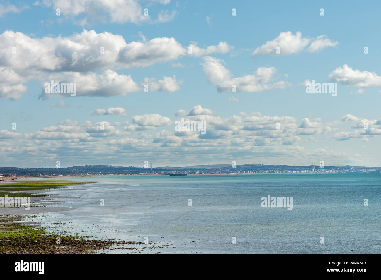 Worthing seafront during low tide on a sunny day looking along the ...