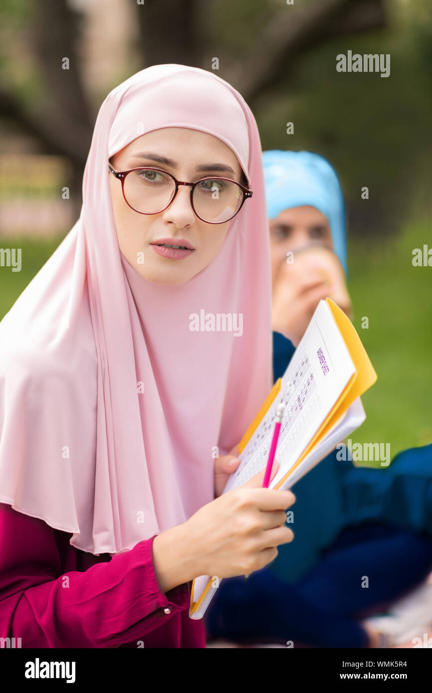 Female muslim students wearing bright hijabs studying together Stock ...
