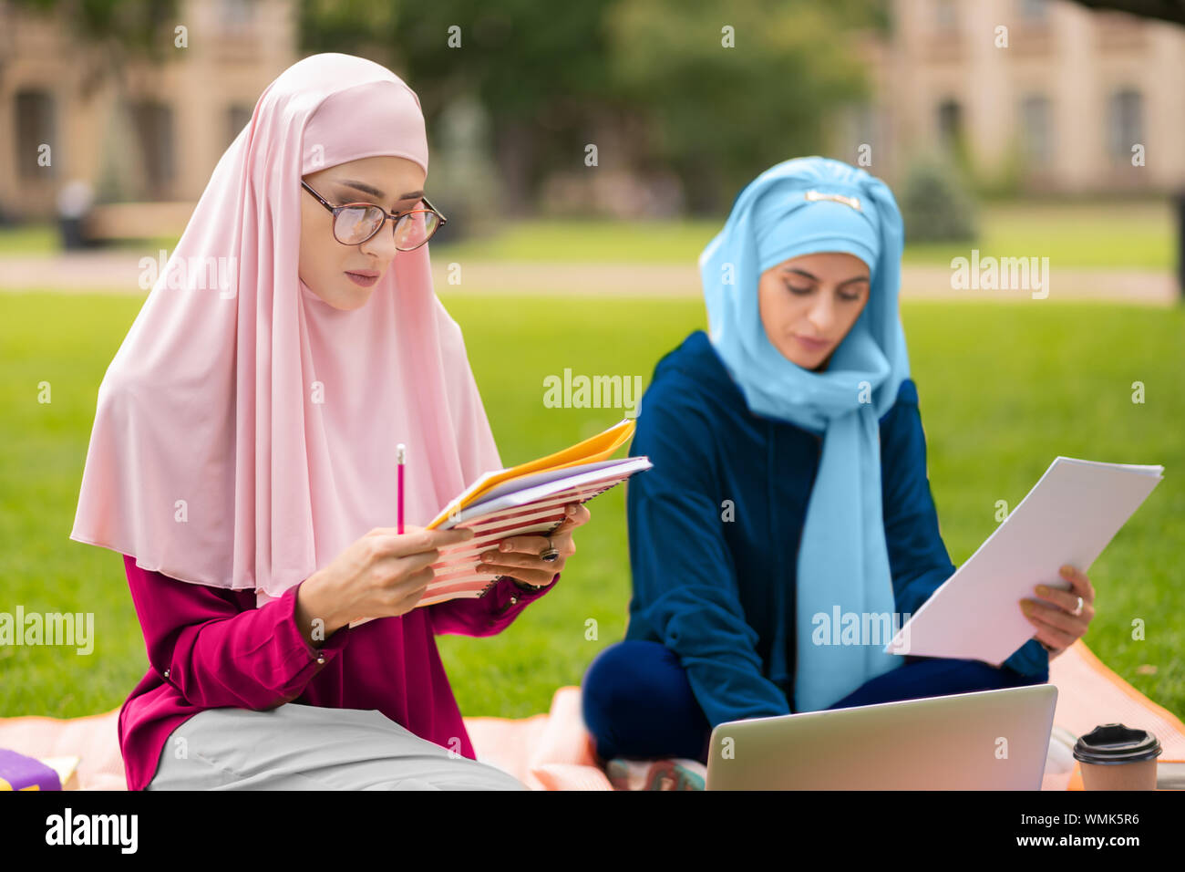 Beautiful muslim student wearing glasses studying with friend Stock ...