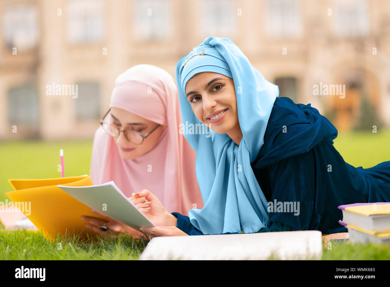 Close up of student wearing hijab holding test sheet and pencil Stock ...