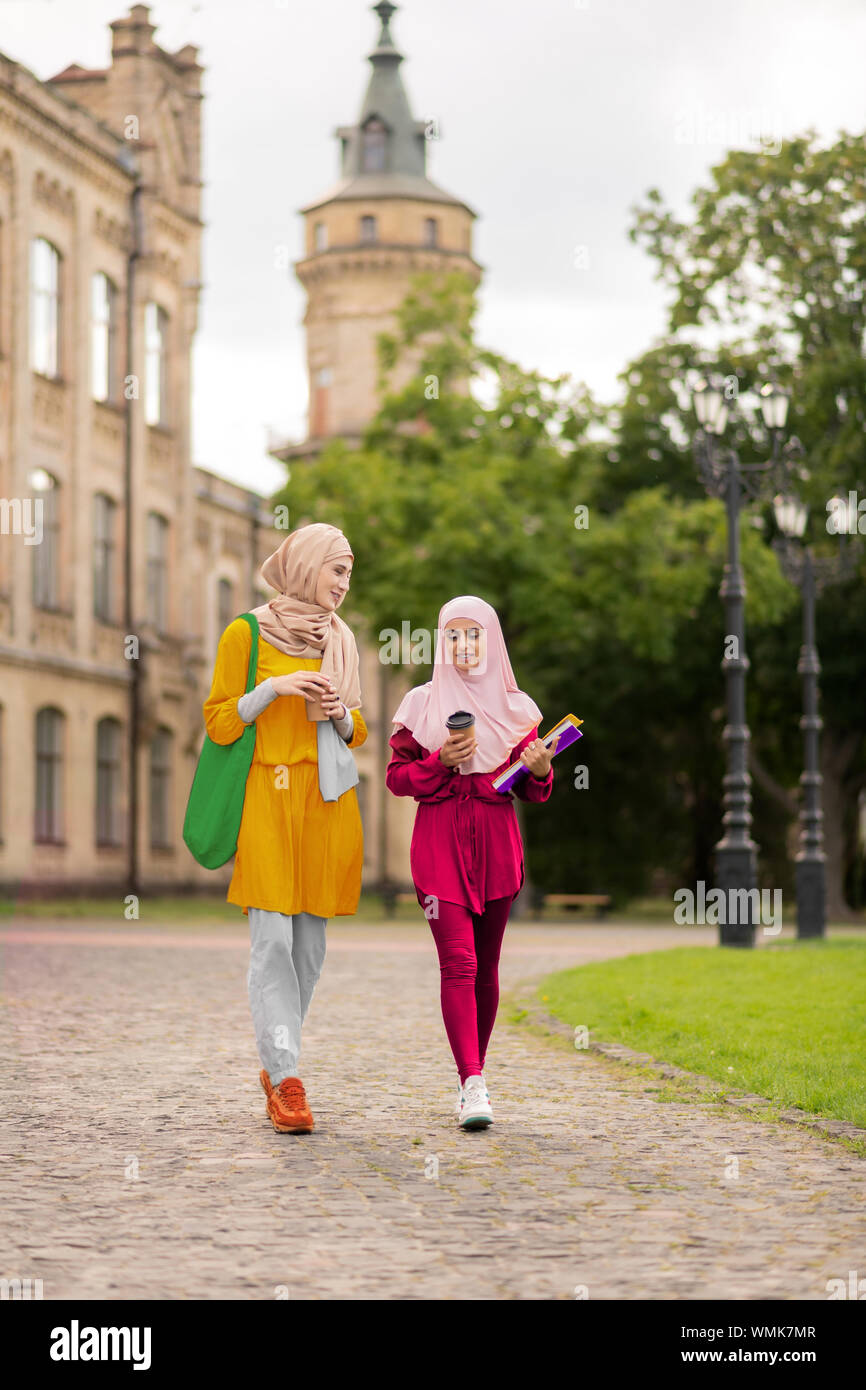 Young muslim women walking to university together Stock Photo - Alamy