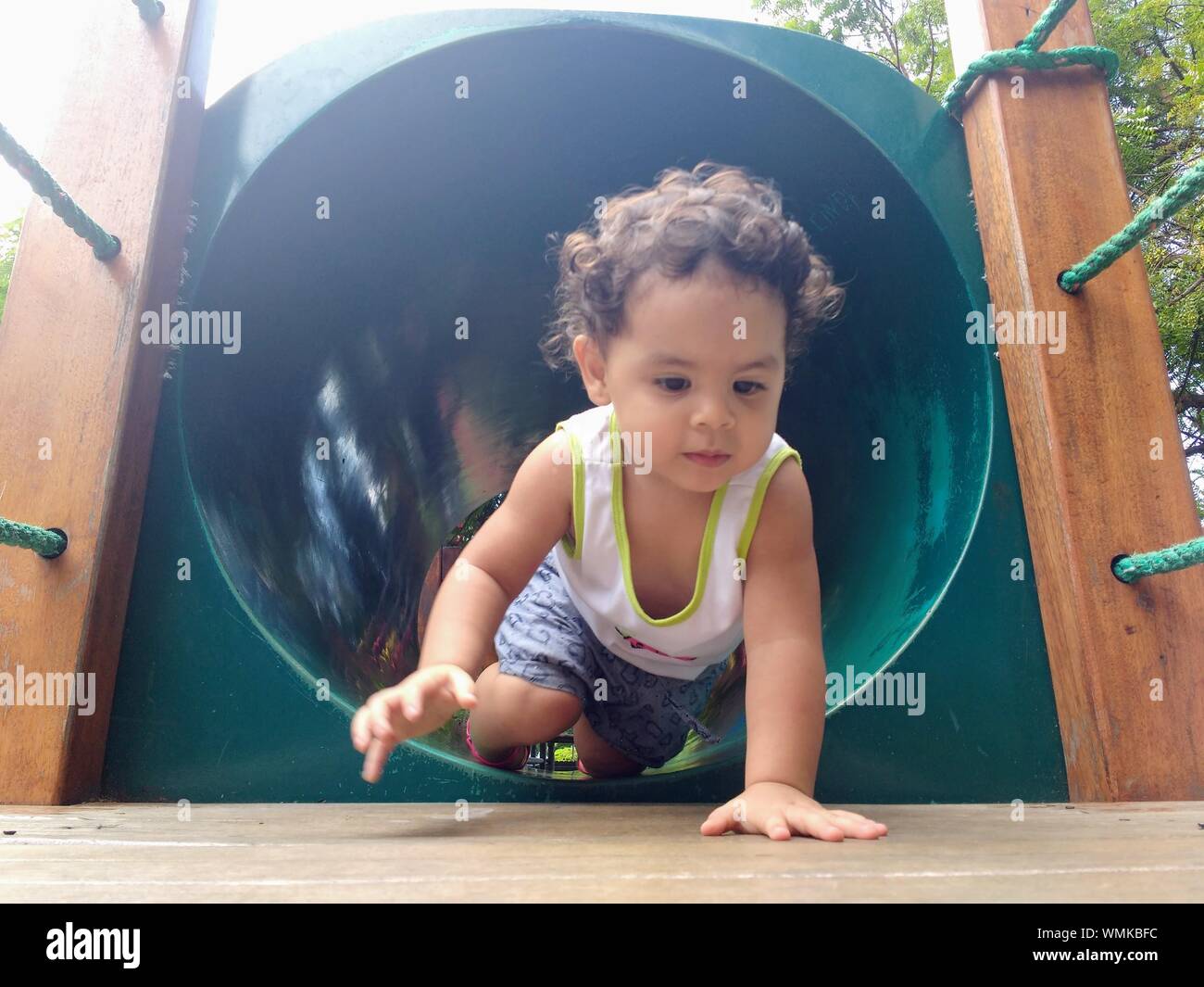 Toddler playing on slide hi-res stock photography and images - Alamy