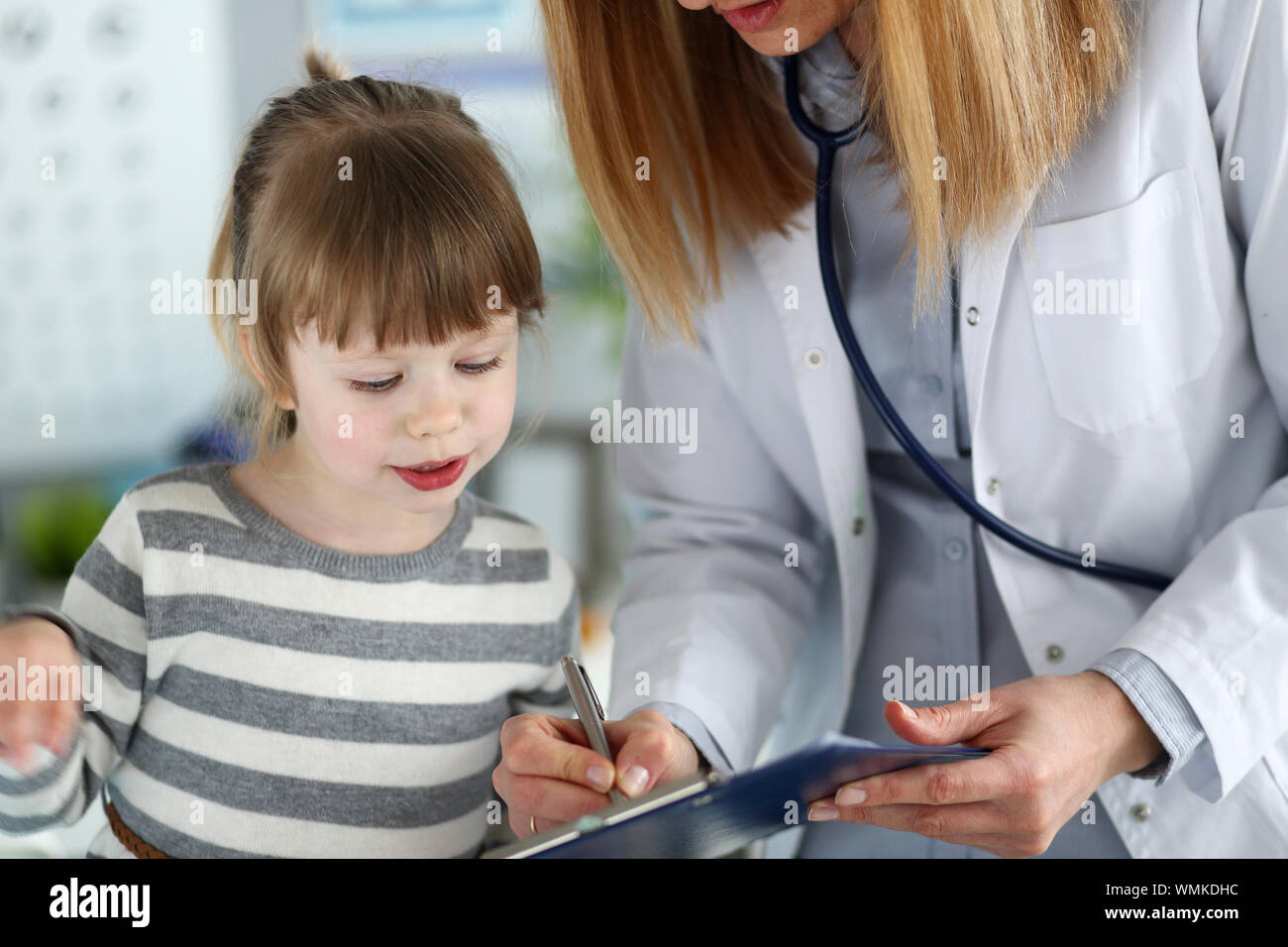Cute child looking at paper folder Stock Photo - Alamy