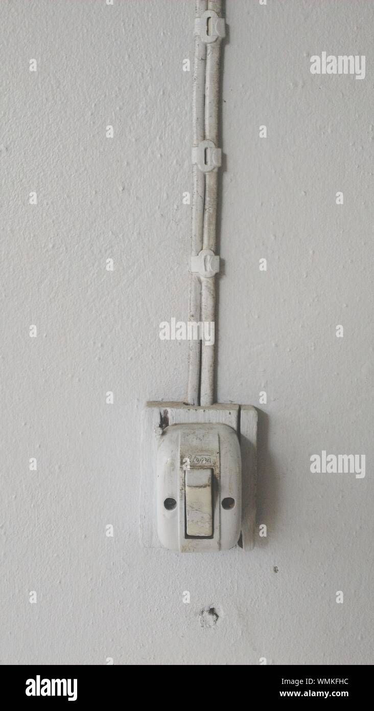 Old Power Switch Mounted On White Wall Stock Photo - Alamy