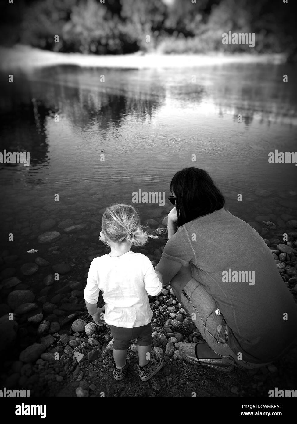 Mother daughter crouching lake hi-res stock photography and images - Alamy