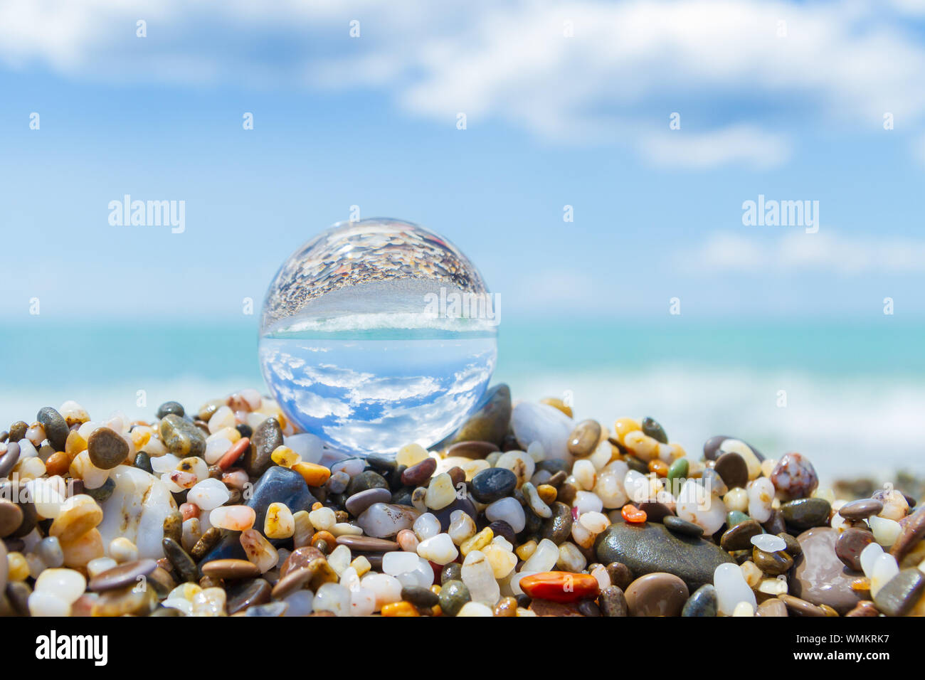 Glass round ball on the beach reflects the sea in summer Stock Photo ...
