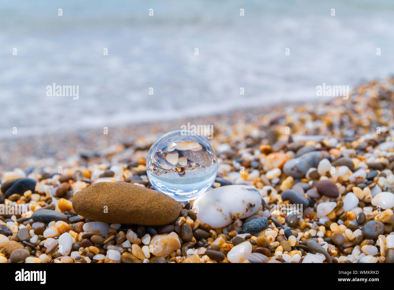 Glass round ball on the beach reflects the sea in summer Stock Photo ...