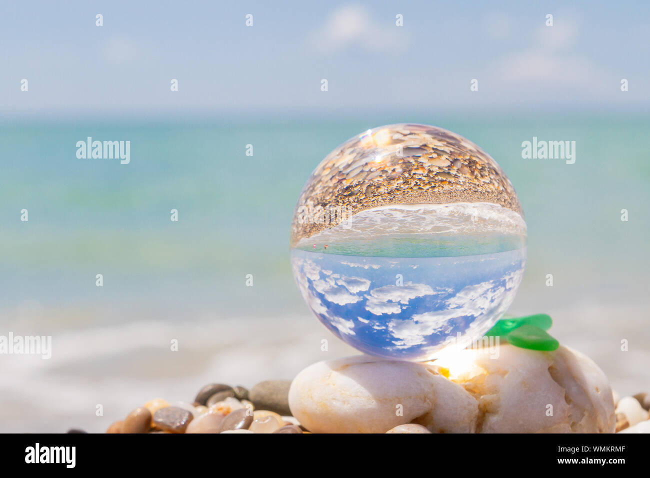 Glass round ball on the beach reflects the sea in summer Stock Photo ...
