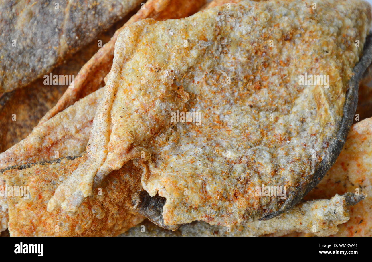 crispy fried fish skin with seasoning on dish Stock Photo - Alamy