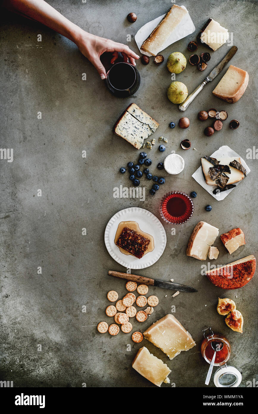 Wine snack variety. Flat-lay of cheeses, honey, fruit, nuts, crackers ...