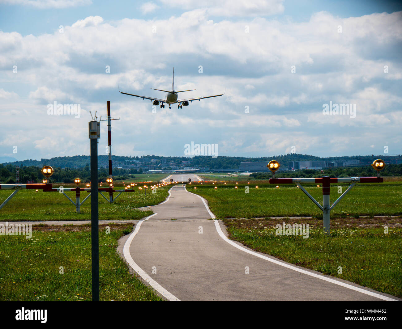 Plane landing on runway at ZRH from the end of the pist perspective ...