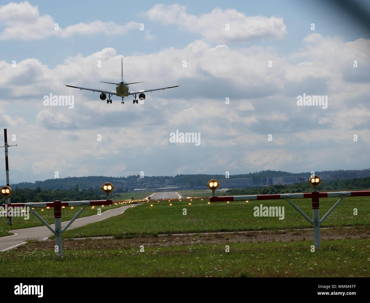 Plane landing on runway at ZRH from the end of the pist perspective ...