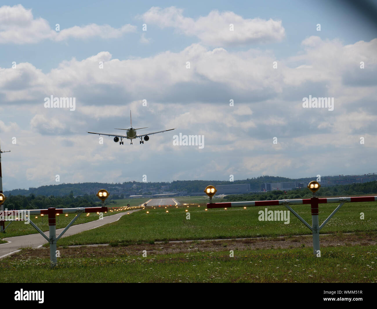 Plane landing on runway at ZRH from the end of the pist perspective ...