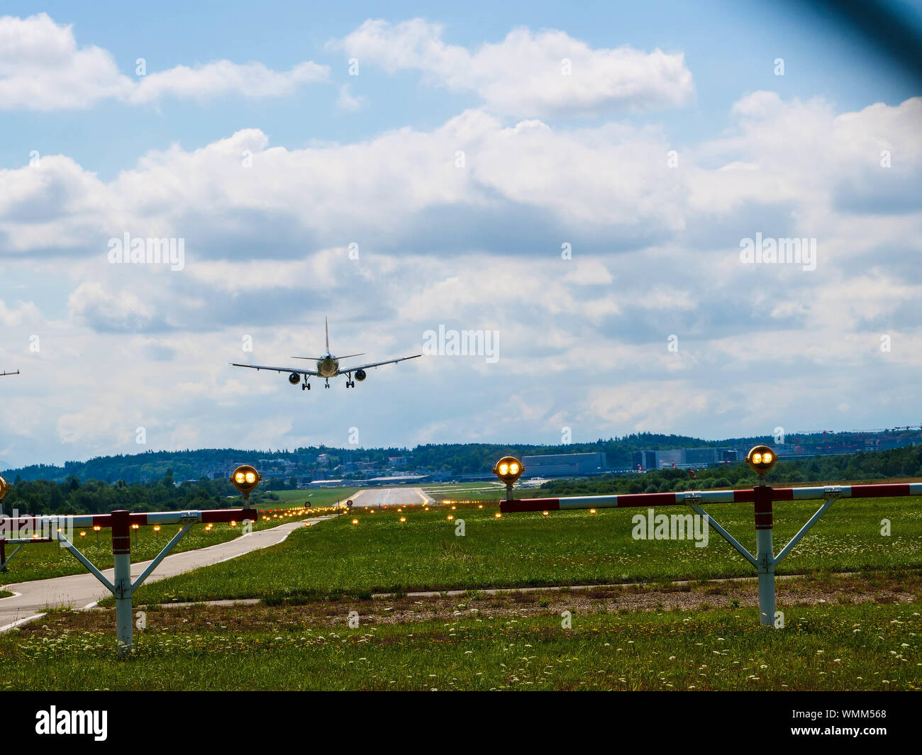 Plane landing on runway at ZRH from the end of the pist perspective ...