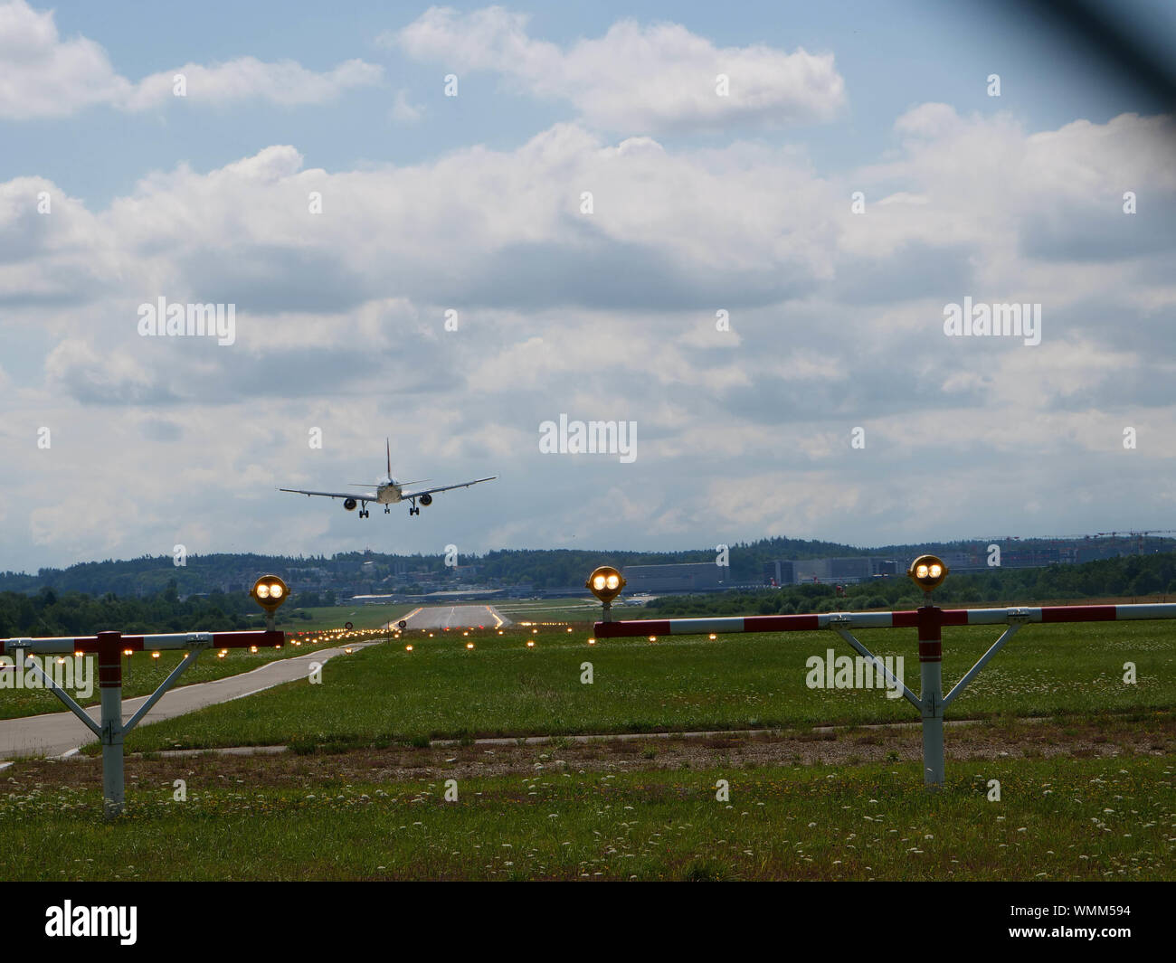 Plane landing on runway at ZRH from the end of the pist perspective ...