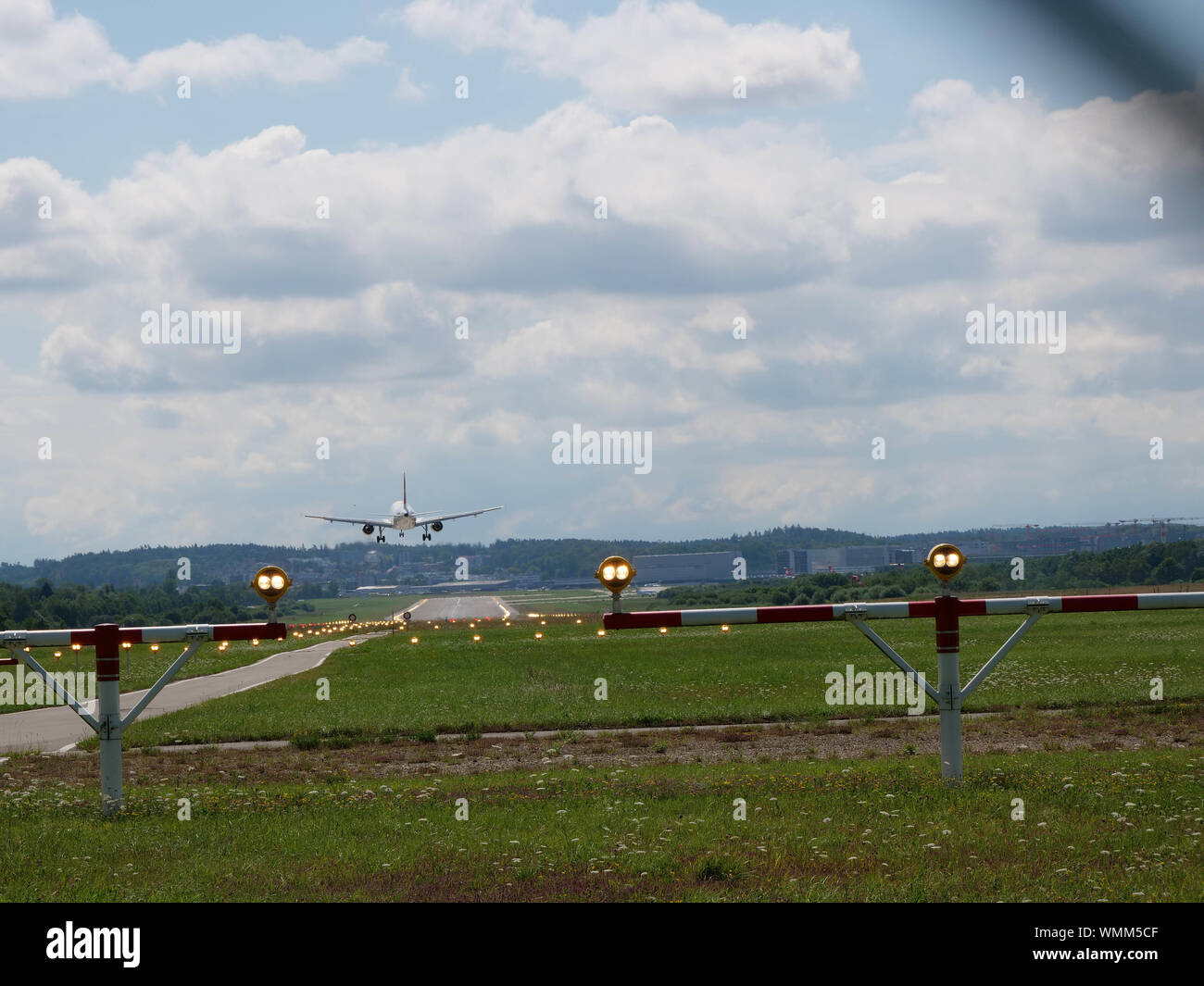 Plane landing on runway at ZRH from the end of the pist perspective ...