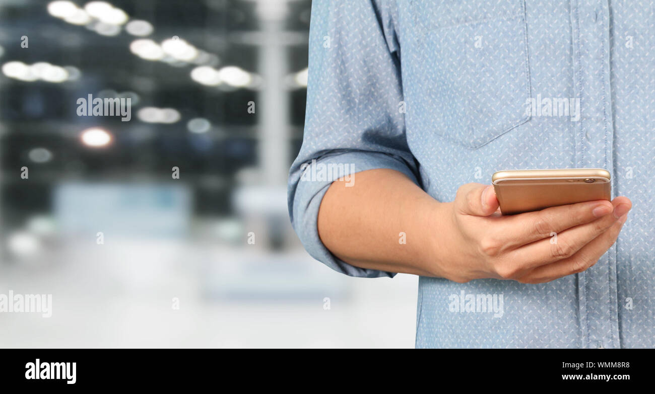 Hand holding the smartphone,device and touching screen Stock Photo - Alamy