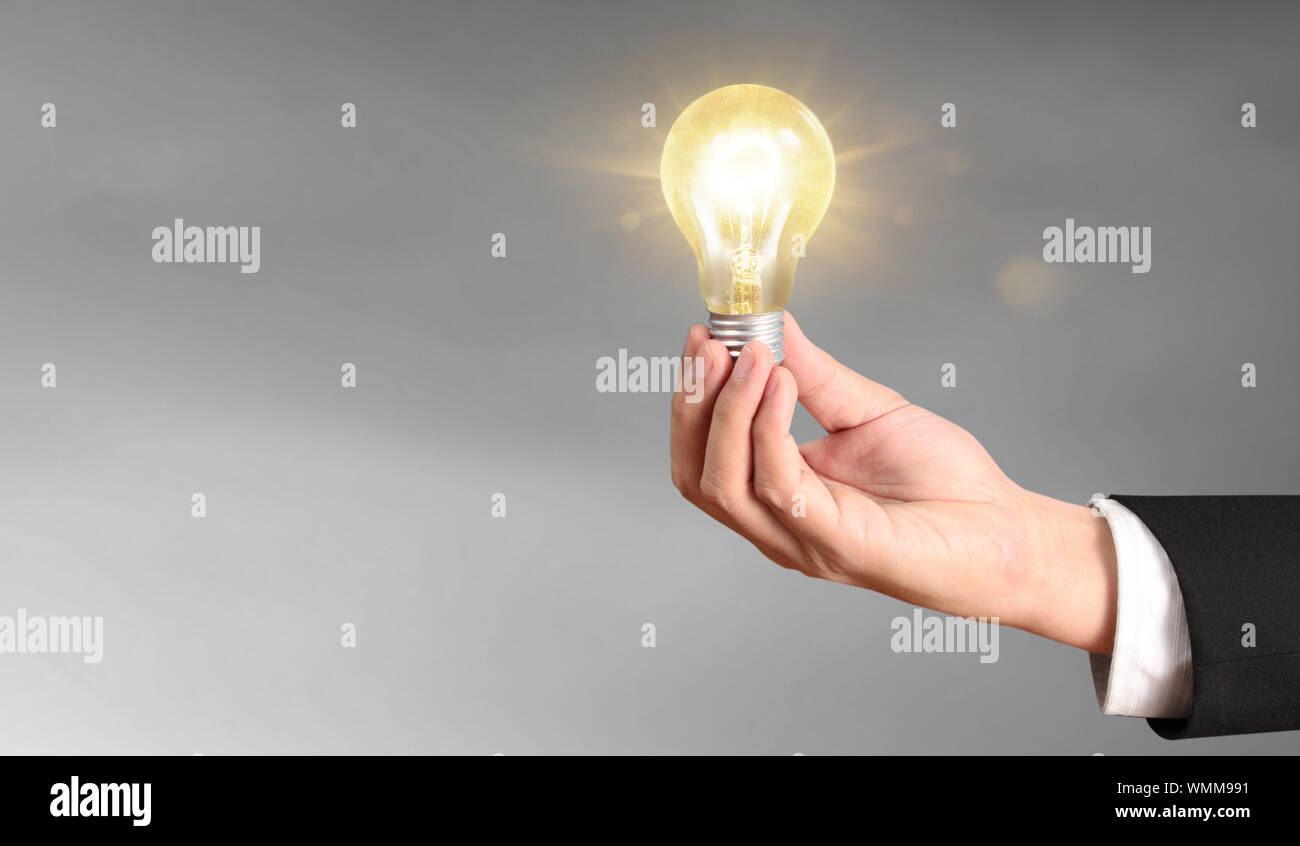 Hand of holding illuminated light bulb, idea, innovation inspiration concept Stock Photo - Alamy
