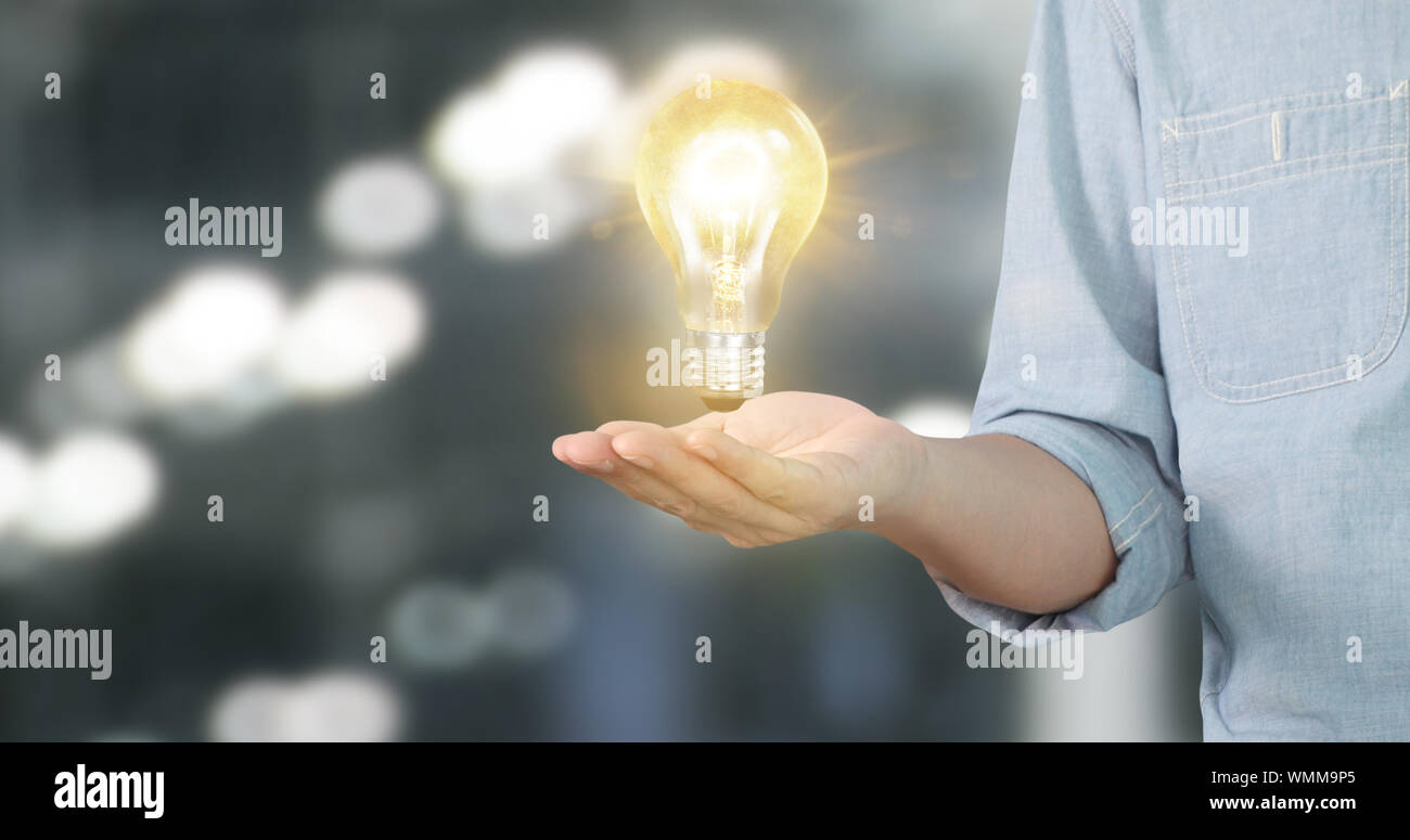 Hand of holding illuminated light bulb, idea, innovation inspiration concept Stock Photo - Alamy