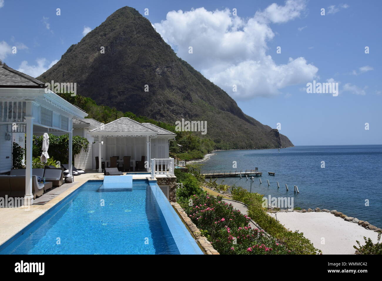 Private pool at a Caribbean resort overlooking mountains and the ocean ...