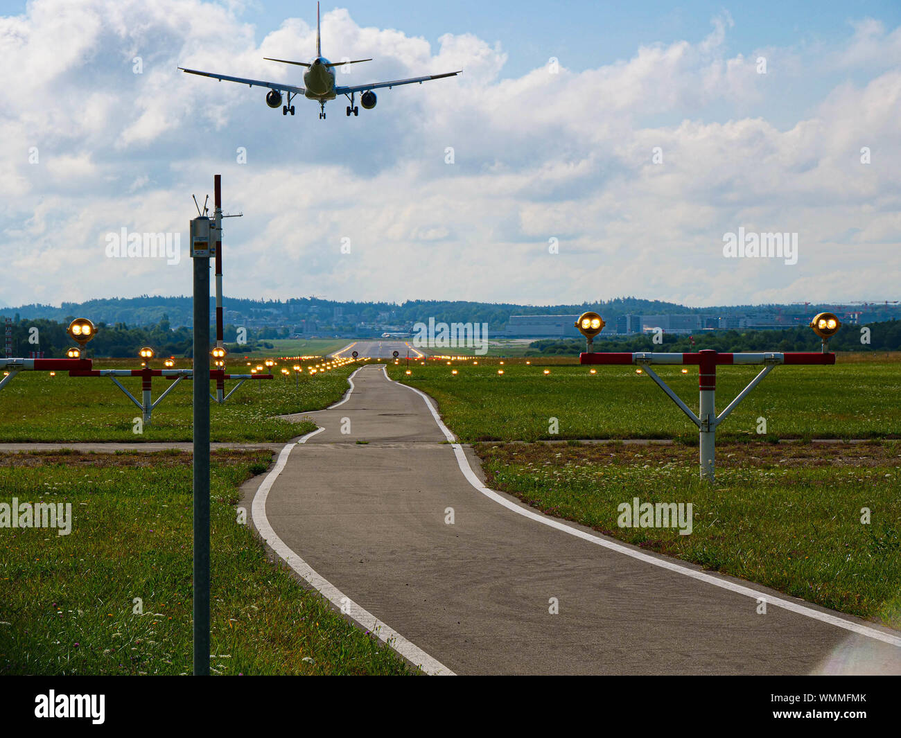 Airplane landing on the lit up runway Stock Photo - Alamy