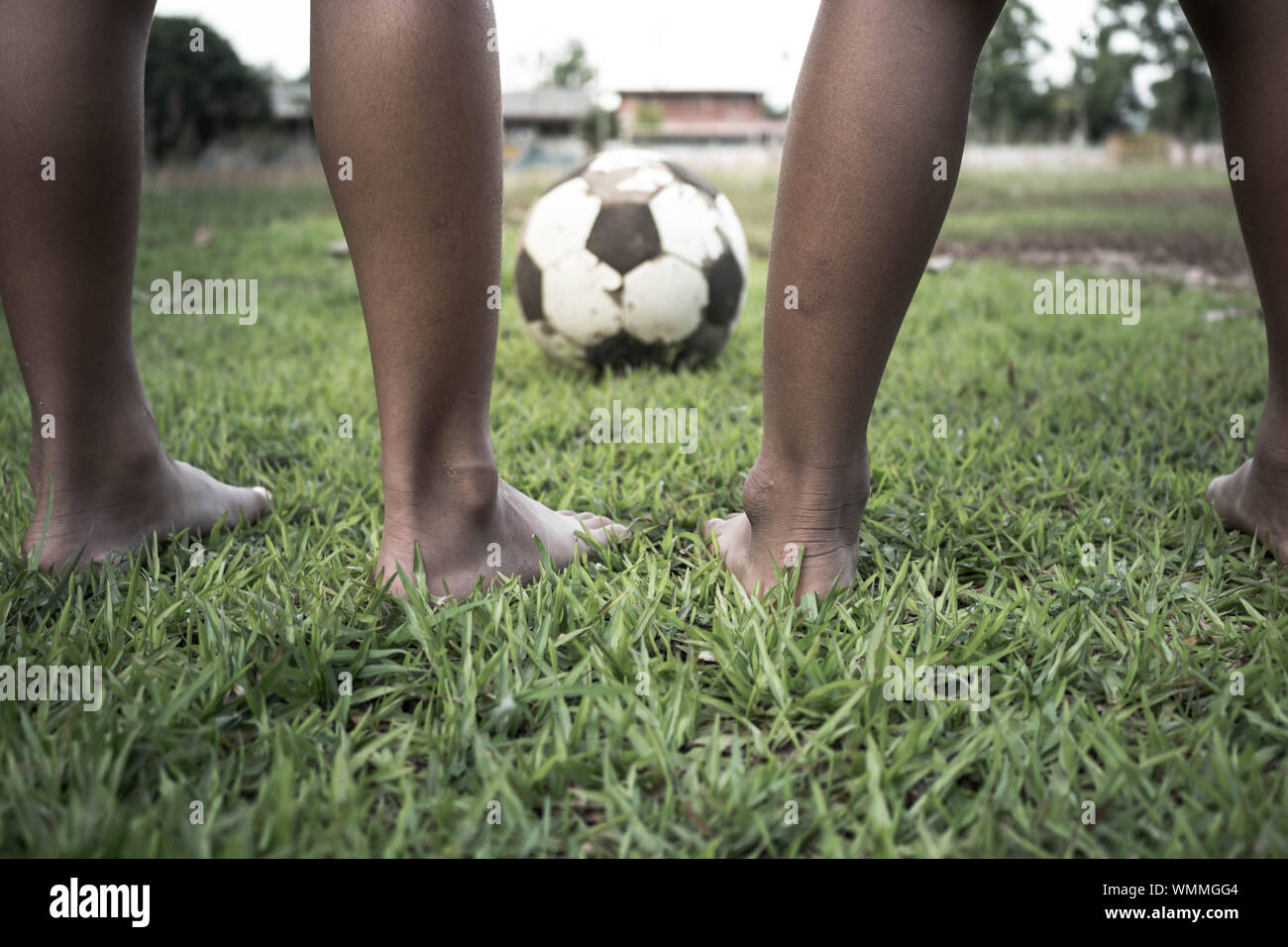 Boys playing soccer barefoot hi-res stock photography and images - Alamy