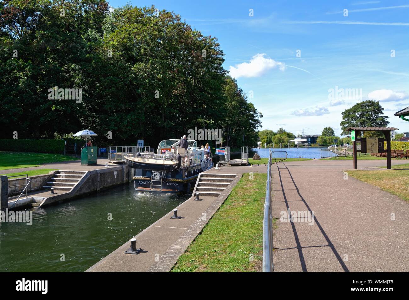 A river cruiser passing through Shepperton lock on a sunny summers day ...