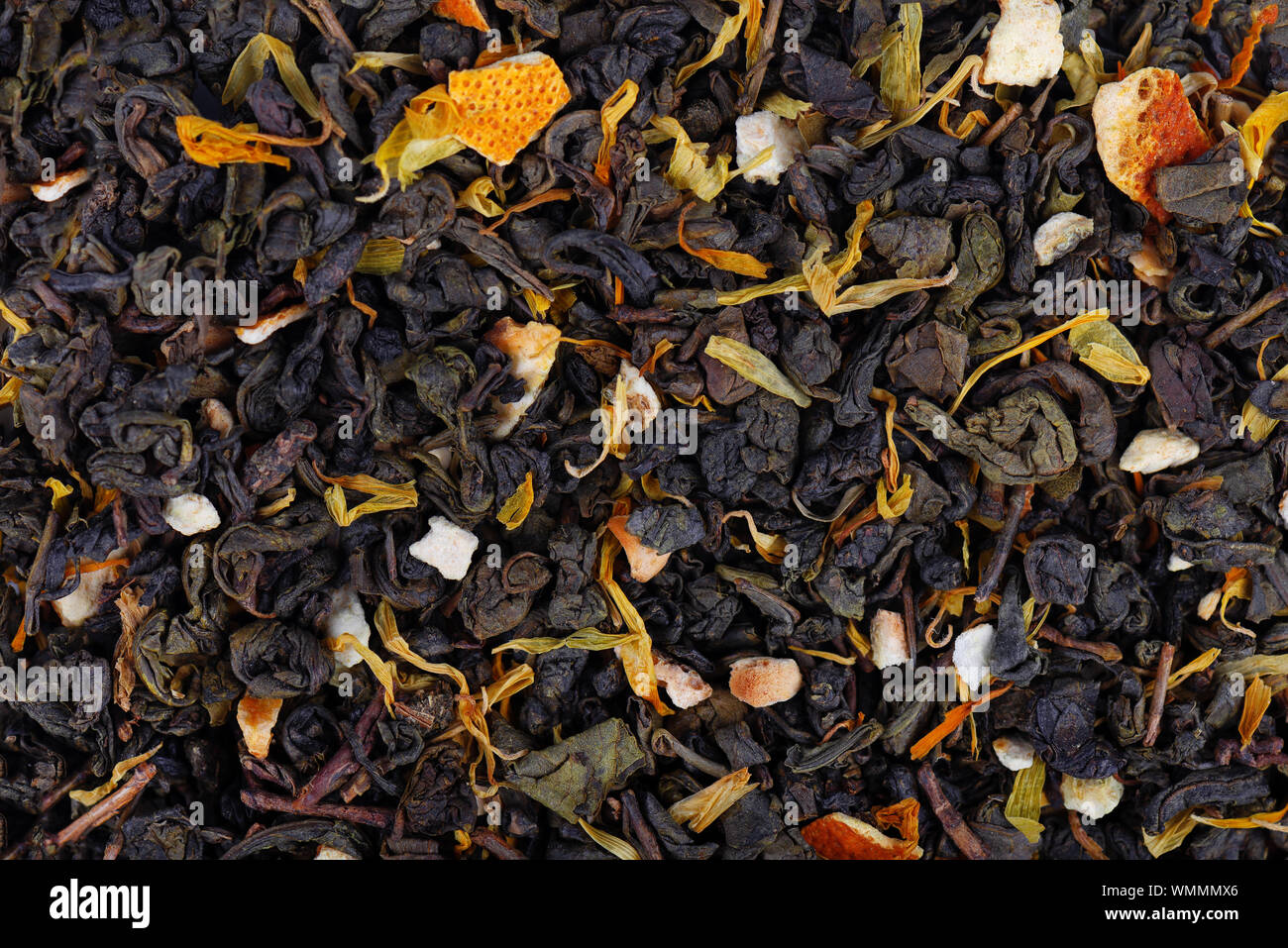 Green Ceylon tea with dry flowers and candied orange background Stock ...