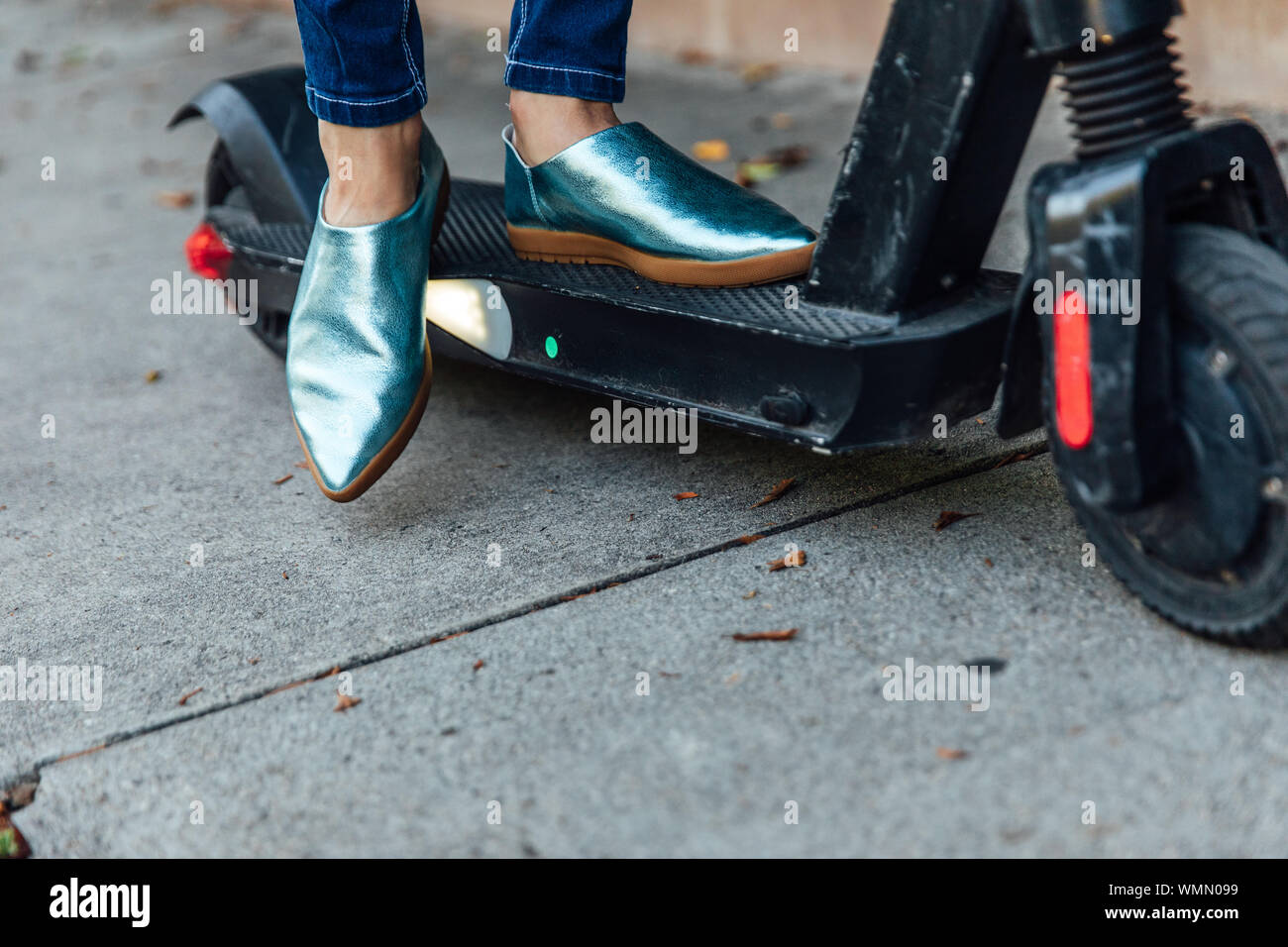 Woman with her feet on a scooter Stock Photo - Alamy