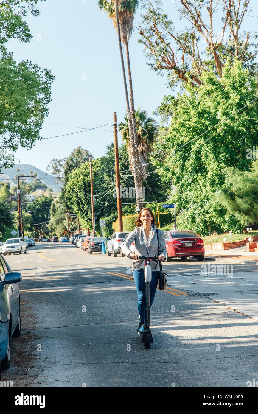 Woman rides scooter hi-res stock photography and images - Alamy