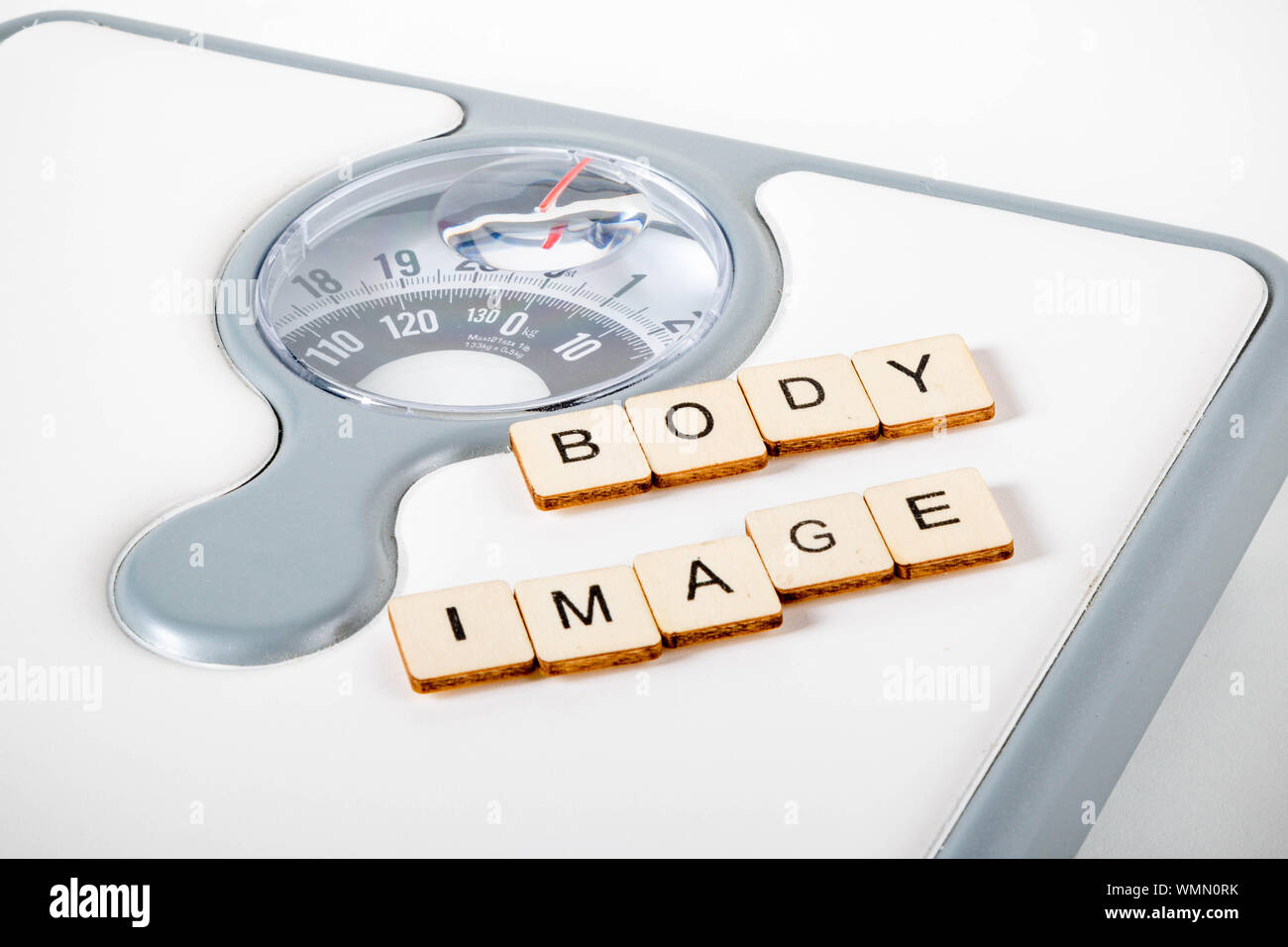 Healthcare concept showing bathroom scales and the message body image ...