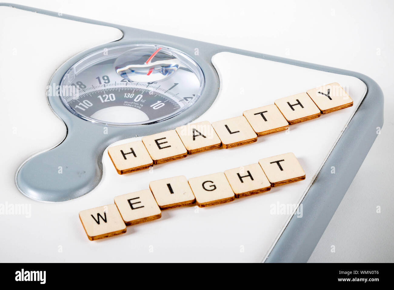 Healthcare concept showing bathroom scales and the message healthy ...
