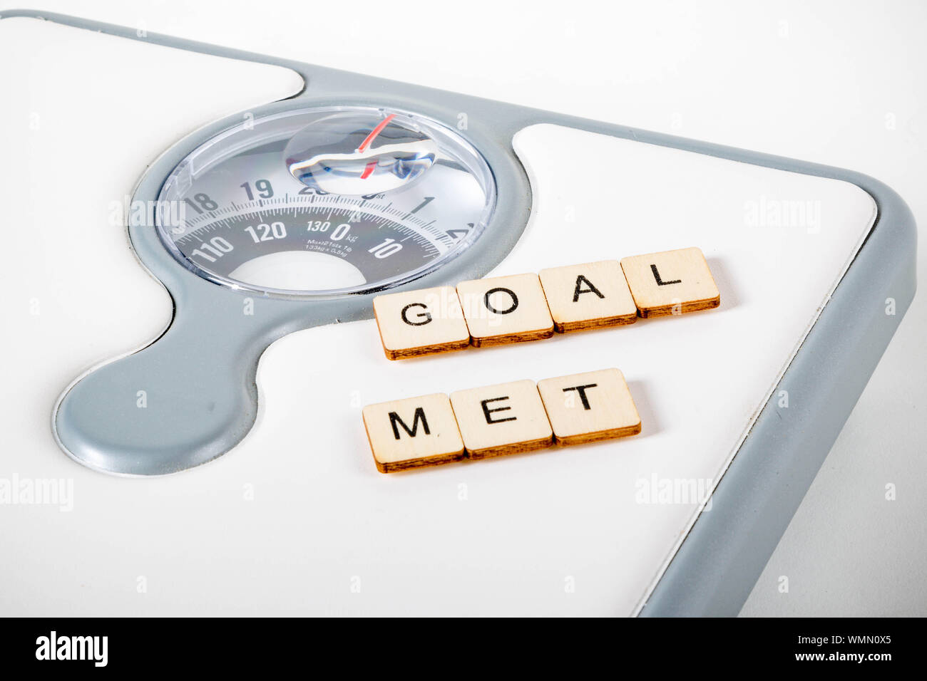 Healthcare concept showing bathroom scales and the message goal met ...