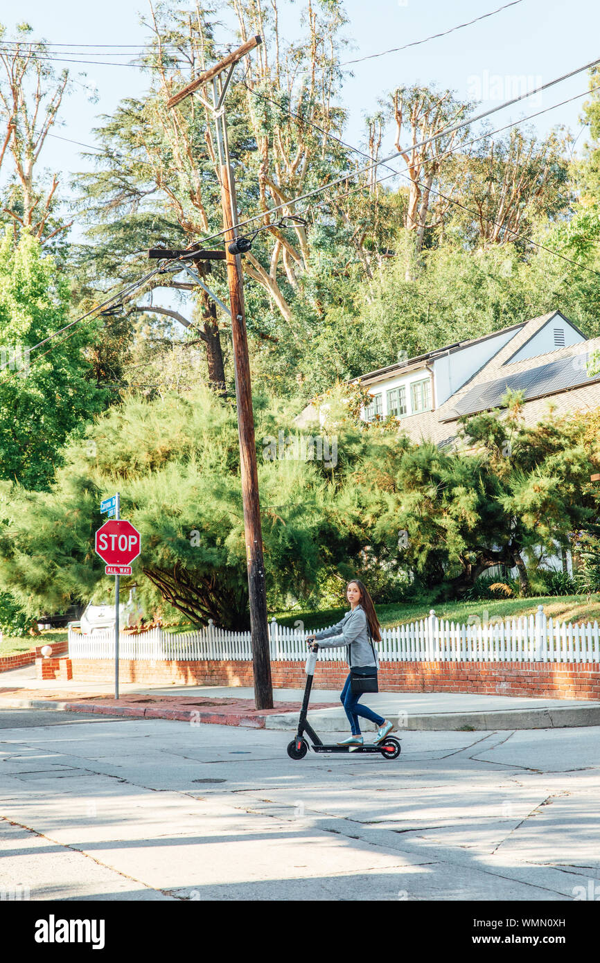 Woman electric scooter crossing hi-res stock photography and images - Alamy