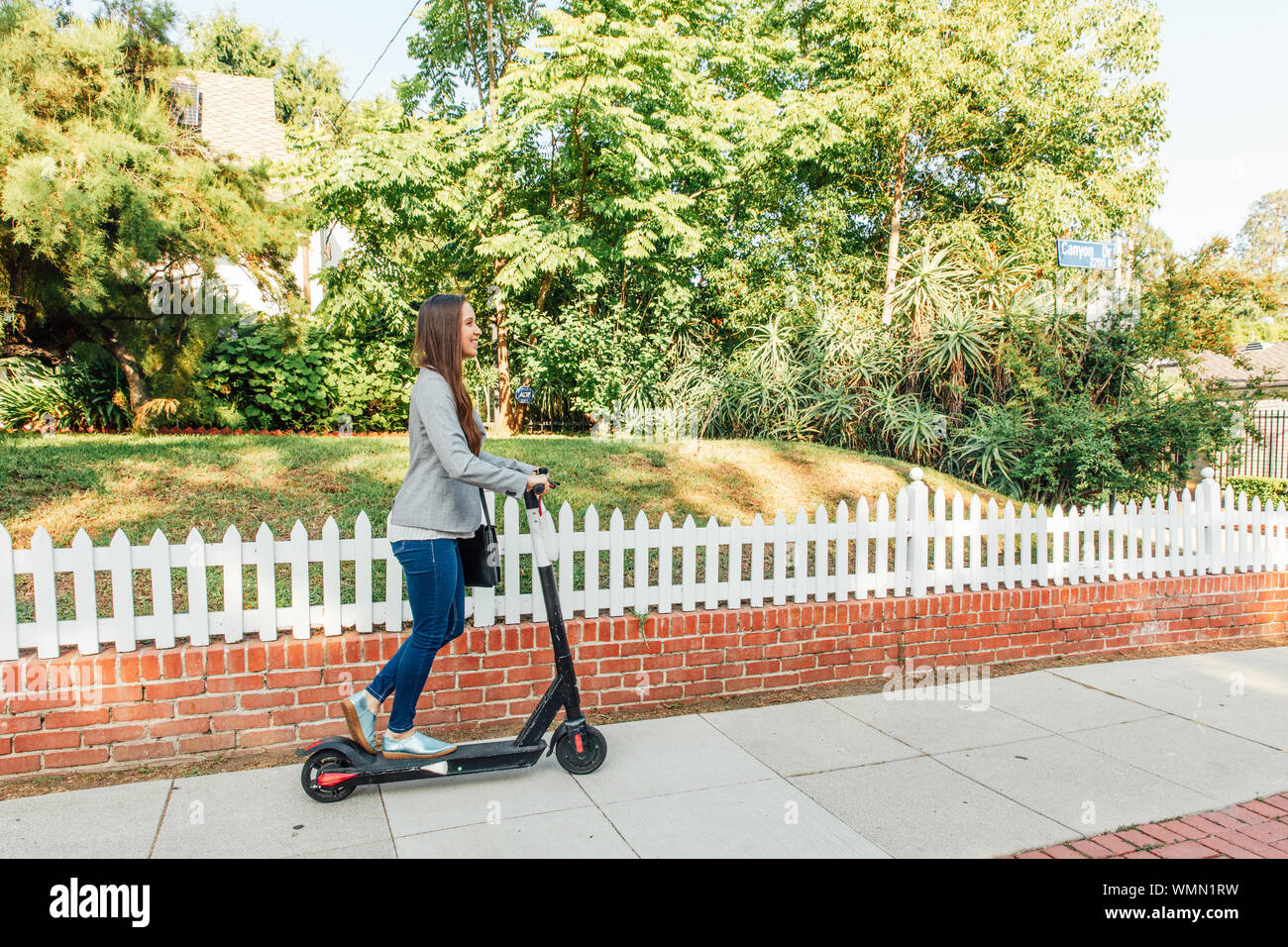 Woman riding her scooter Stock Photo - Alamy