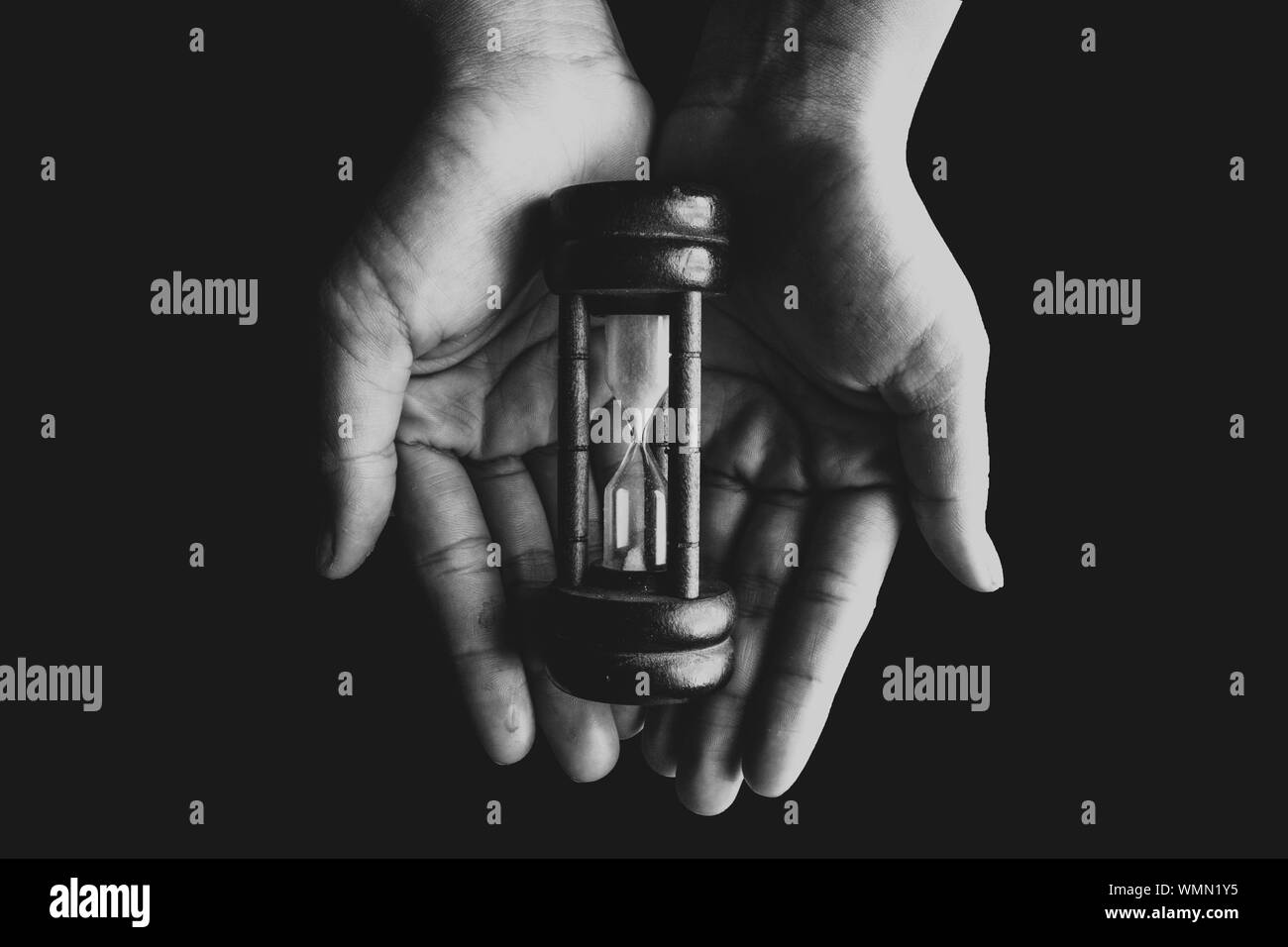 Holding hourglass hi-res stock photography and images - Alamy