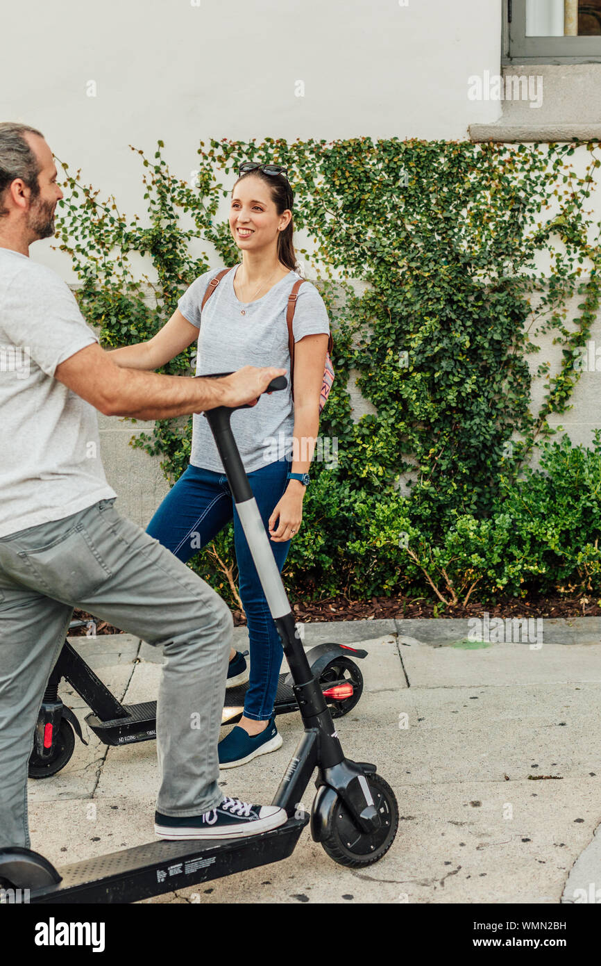 People on scooters outside Stock Photo - Alamy