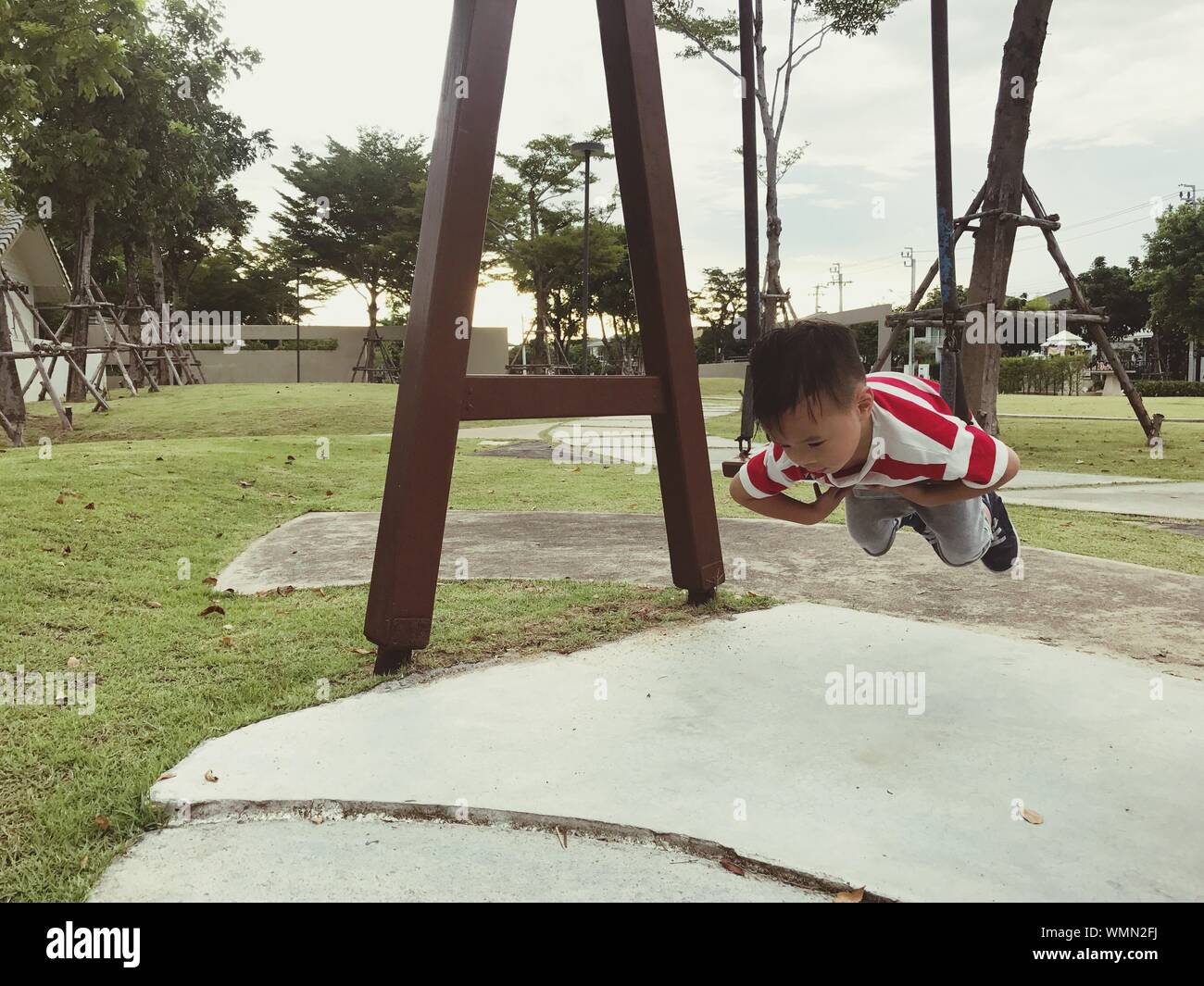 Boy playing swing hi-res stock photography and images - Alamy