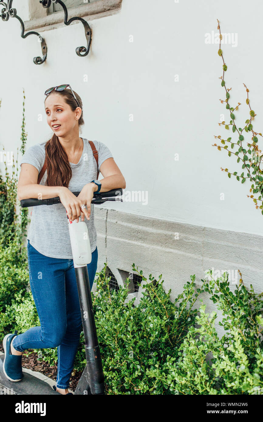 Woman rides scooter hi-res stock photography and images - Alamy