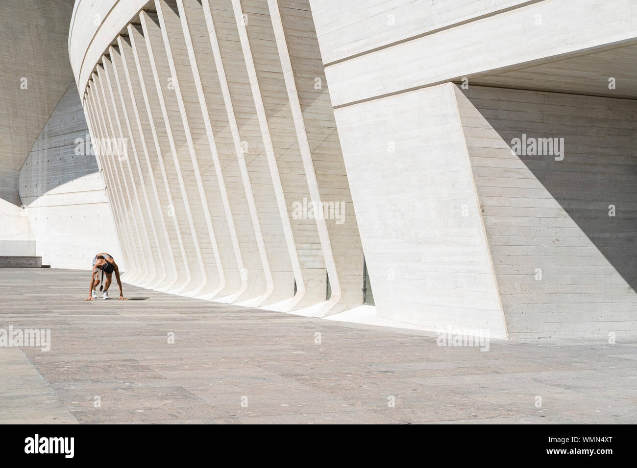 Pulled back view of female athlete in starting position Stock Photo - Alamy