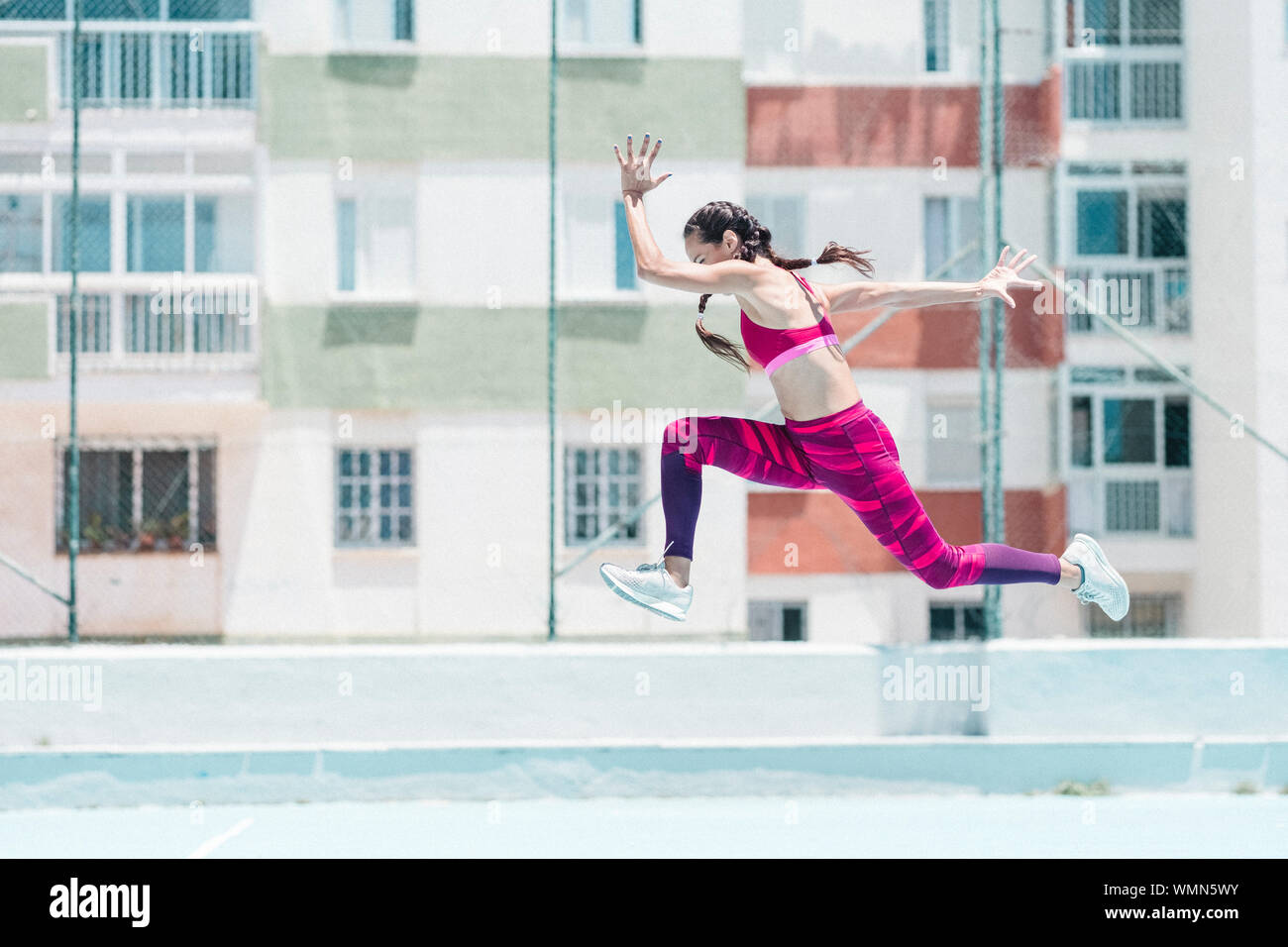 Colorful image of full body of female athlete jumping on court Stock ...