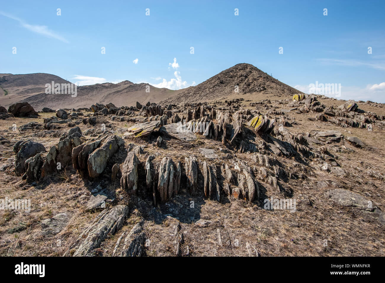 Beautiful flat sharp stones stick out of the ground on a hill ...