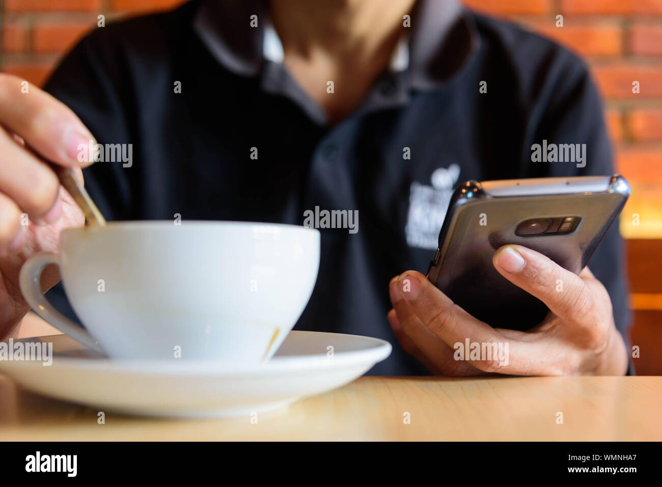 The man use smartphone in coffee shop Stock Photo - Alamy