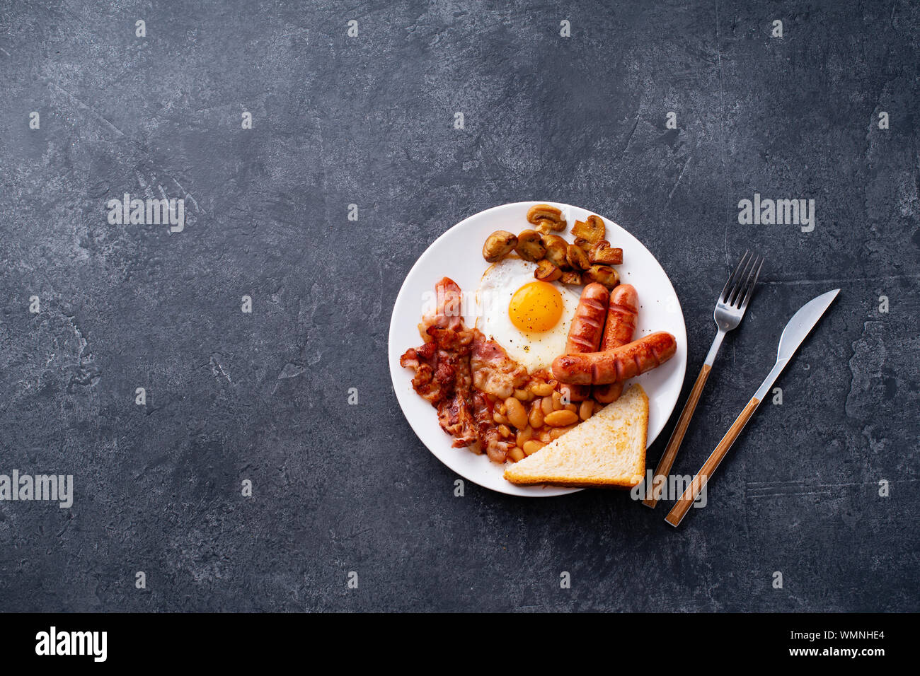 Top view flatlay with classical english breakfast with fried bacon ...