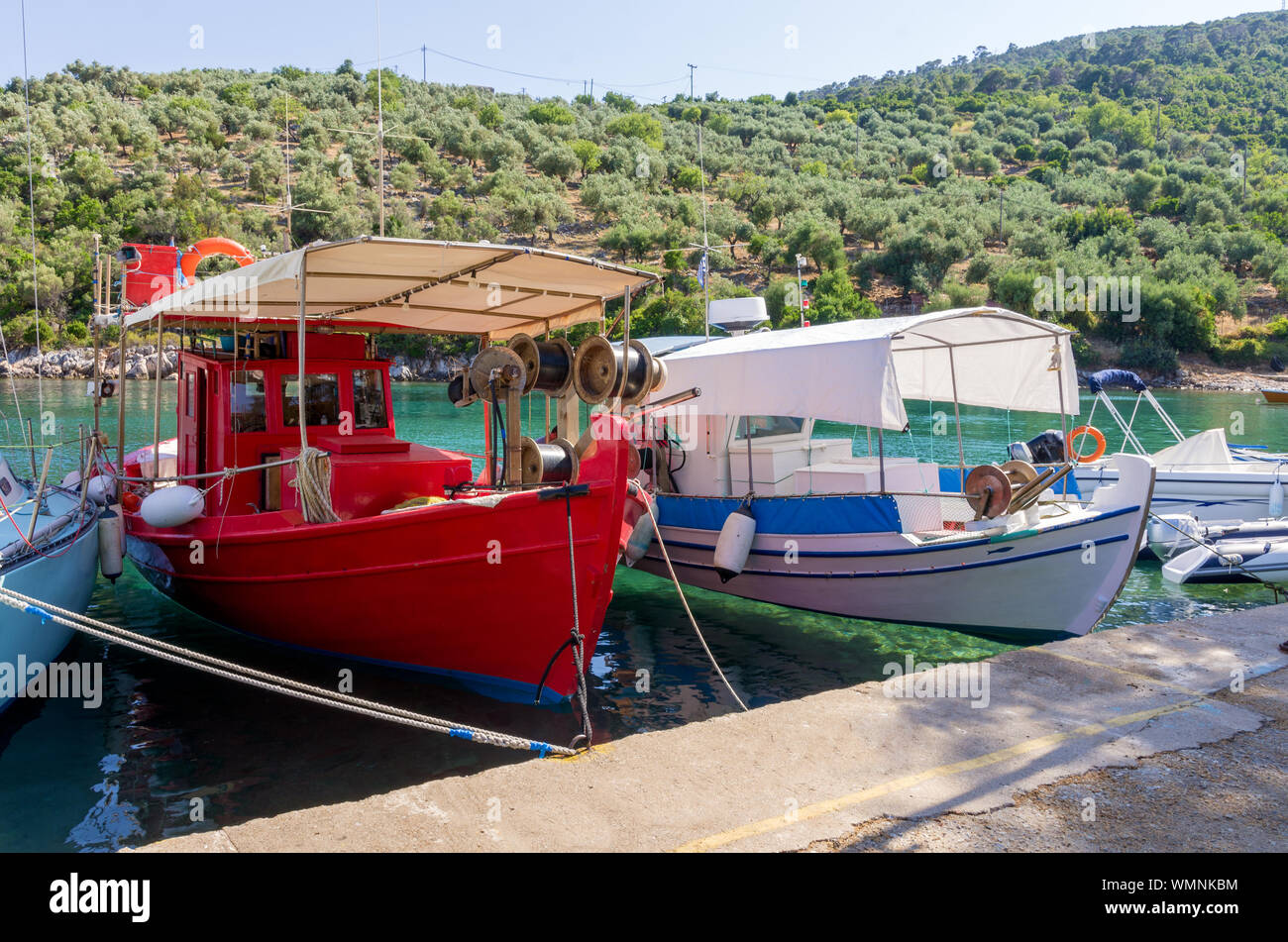 Fishing boats in the picturesque little harbor of Steni Vala village ...