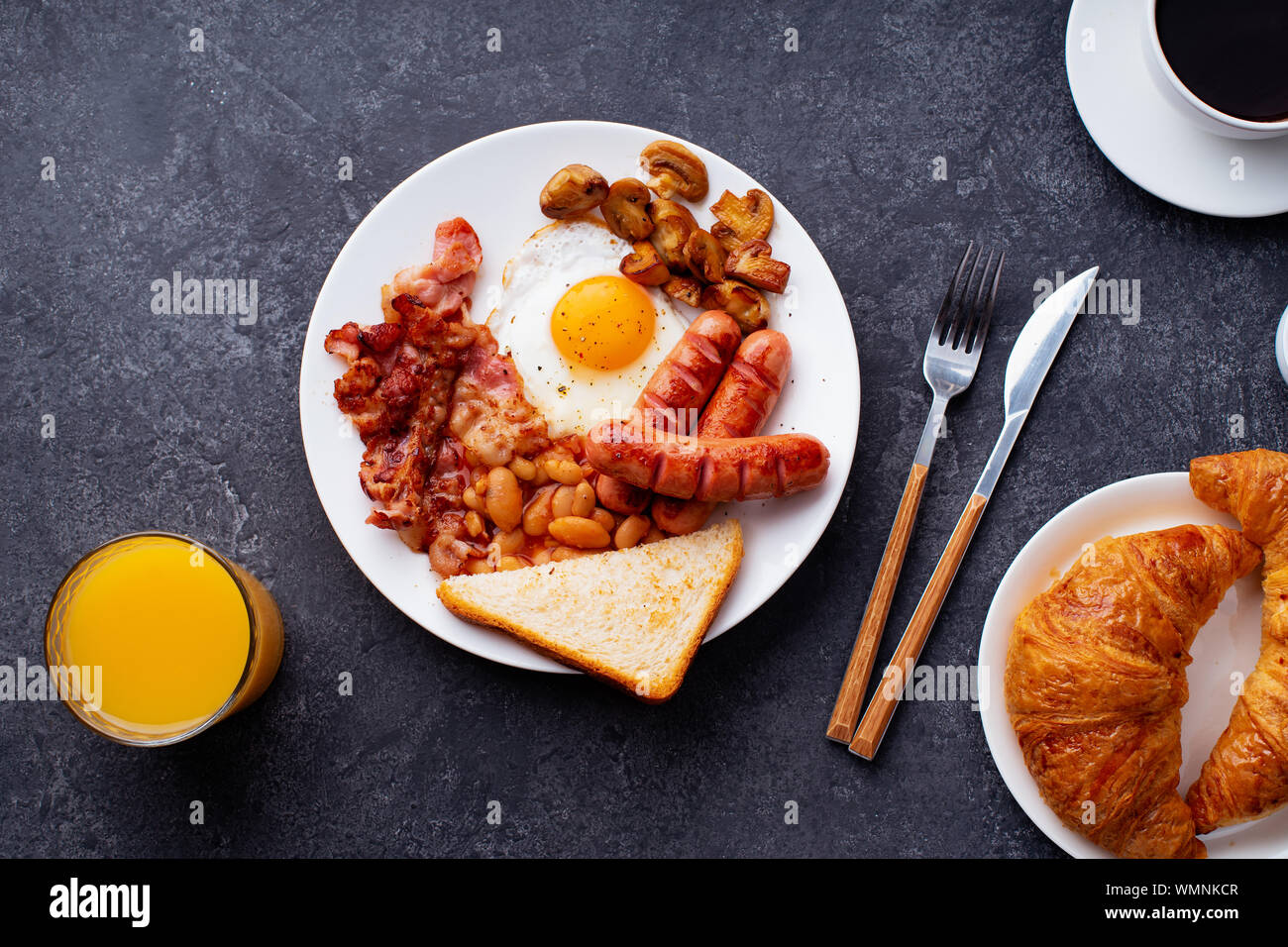 Classical english breakfast with fried bacon, mushrooms and eggs ...