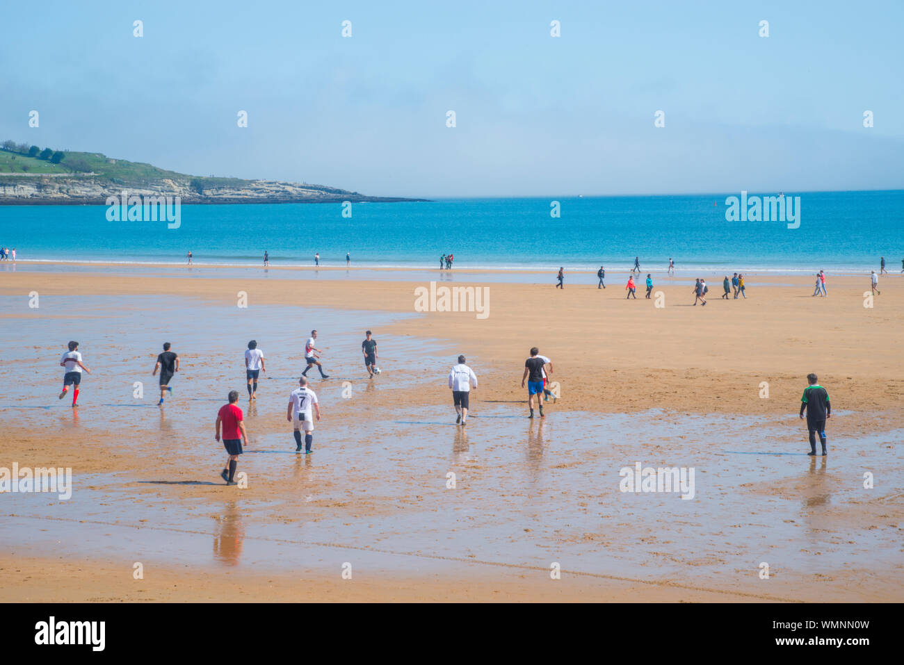 People playing football in the beach. El Sardinero, Santander, Spain ...