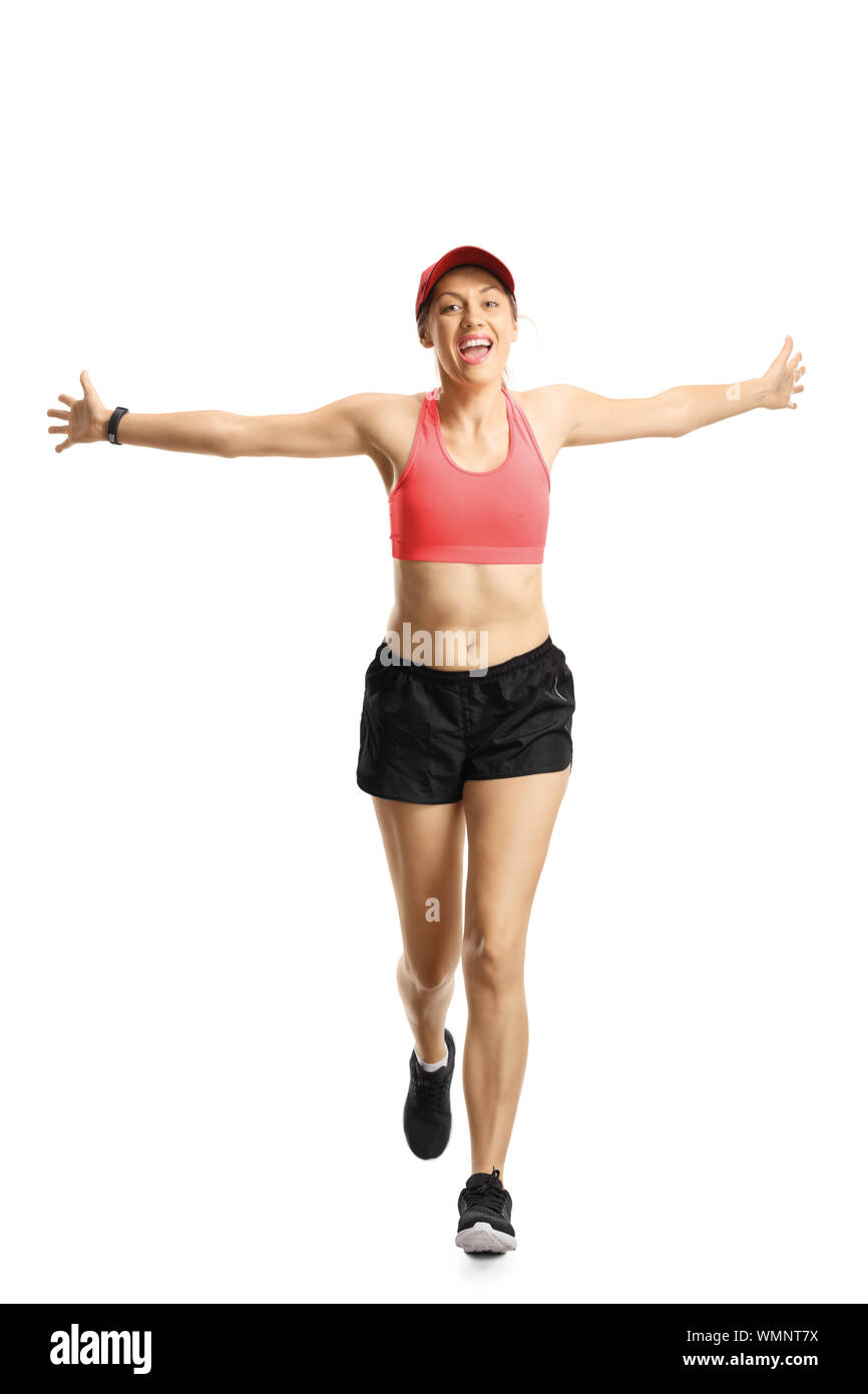 Full length portrait of a young smiling woman in sportswear running and ...