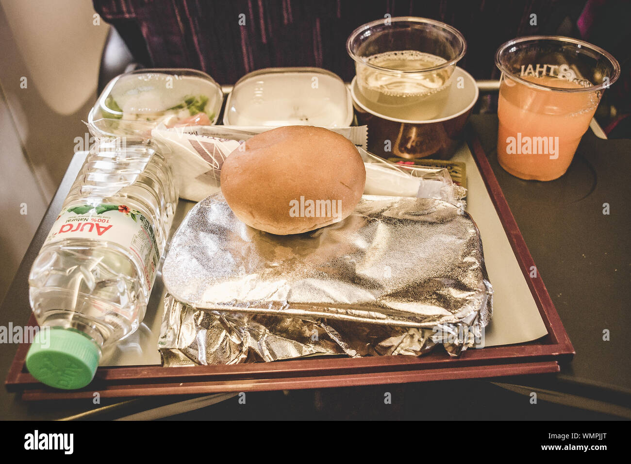 airline inflight economy class meal served on a tray with a bottle of ...